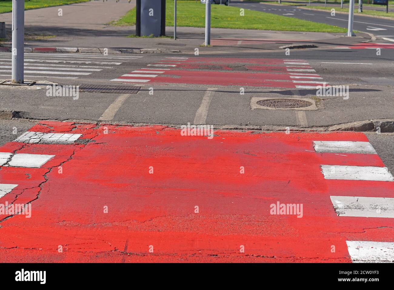 Red paint street crossing for bicycles Stock Photo - Alamy