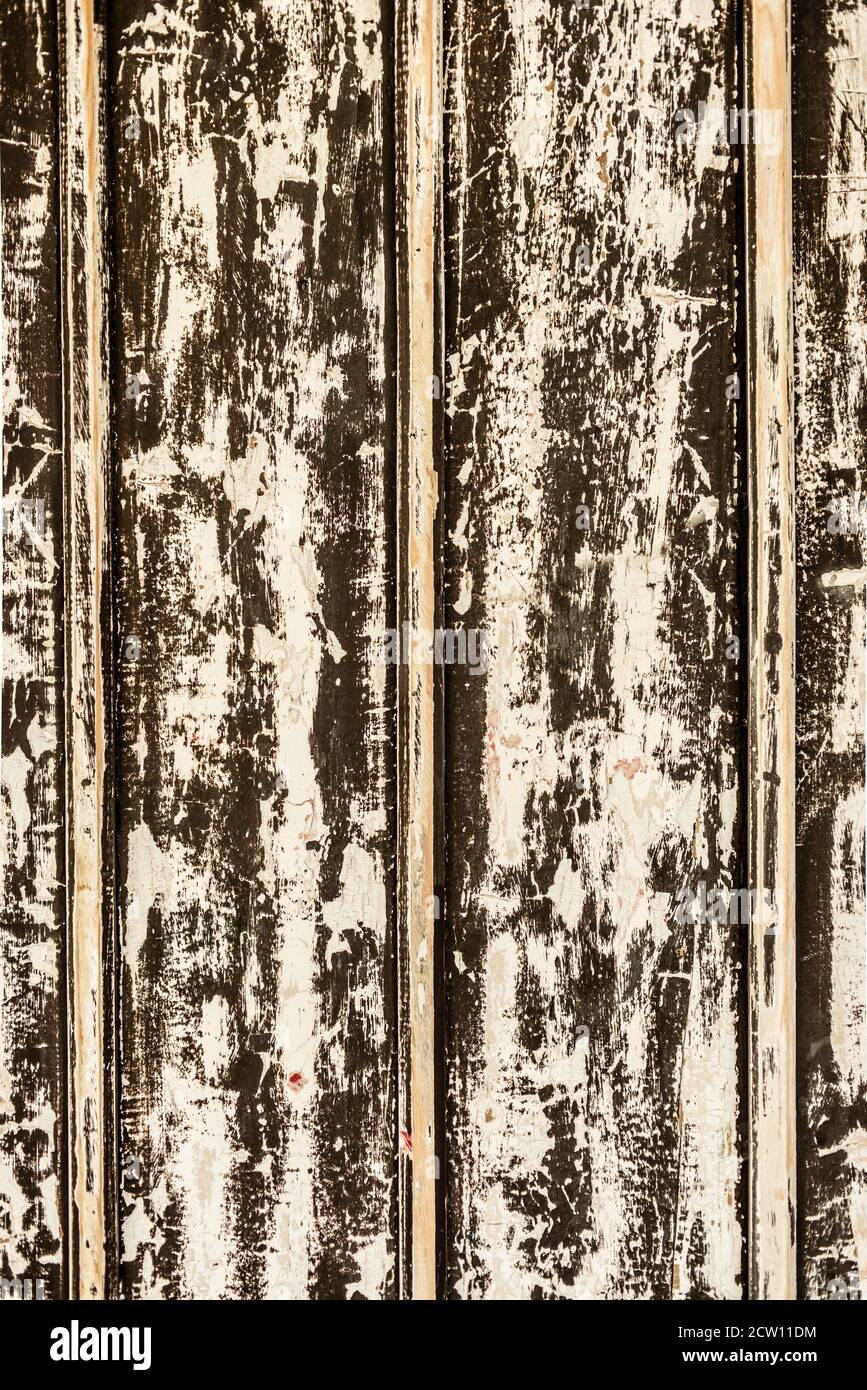 Close up of aged wood wall made of planks with chipped white paint ...