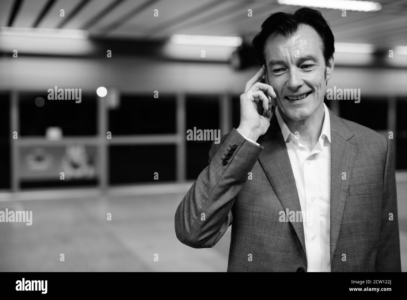 Mature handsome businessman smartphone Black and White Stock Photos ...