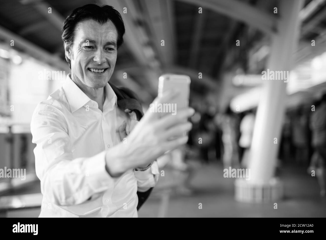Mature handsome businessman exploring around the city Stock Photo - Alamy