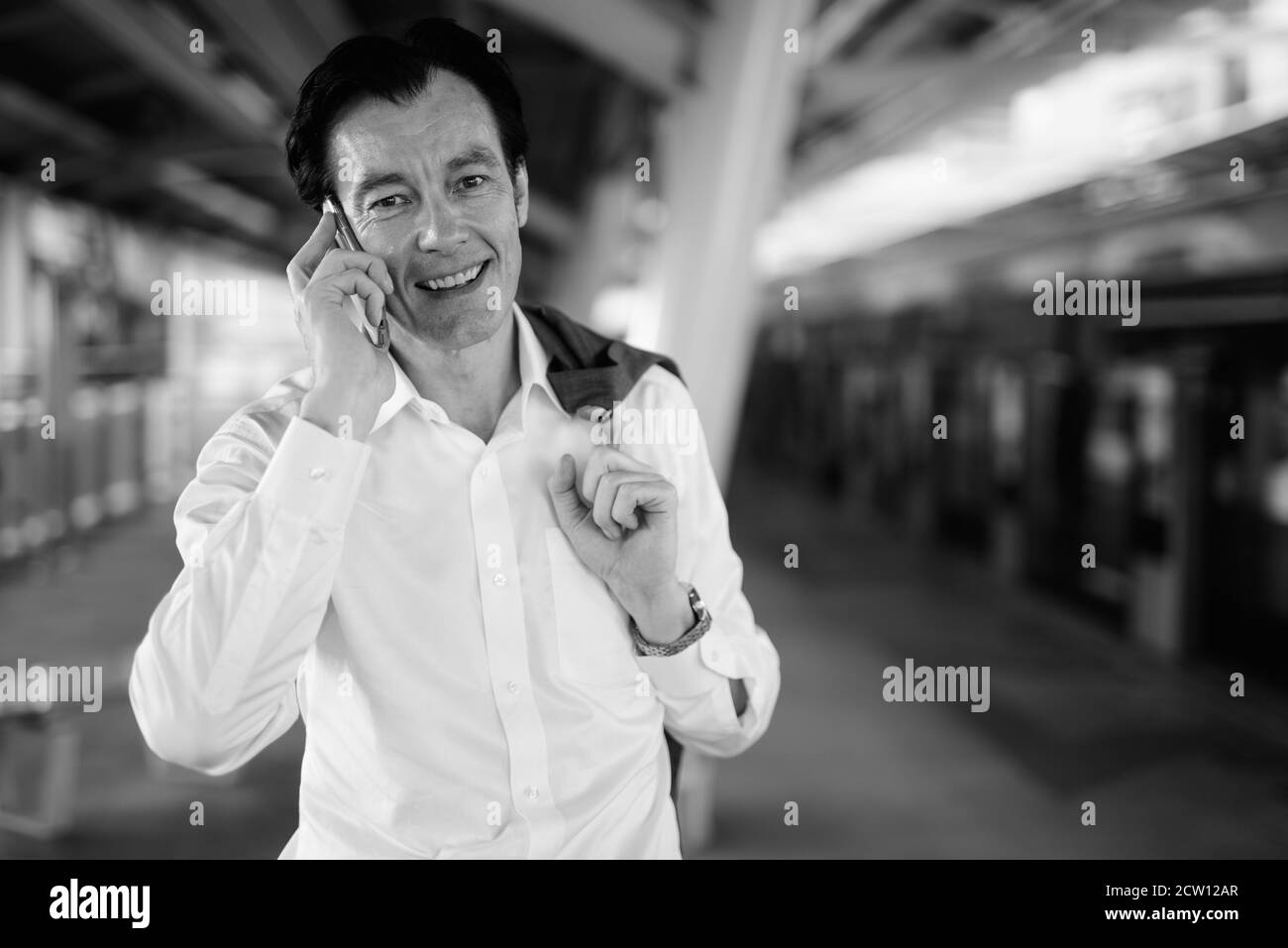 Mature handsome businessman exploring around the city Stock Photo - Alamy