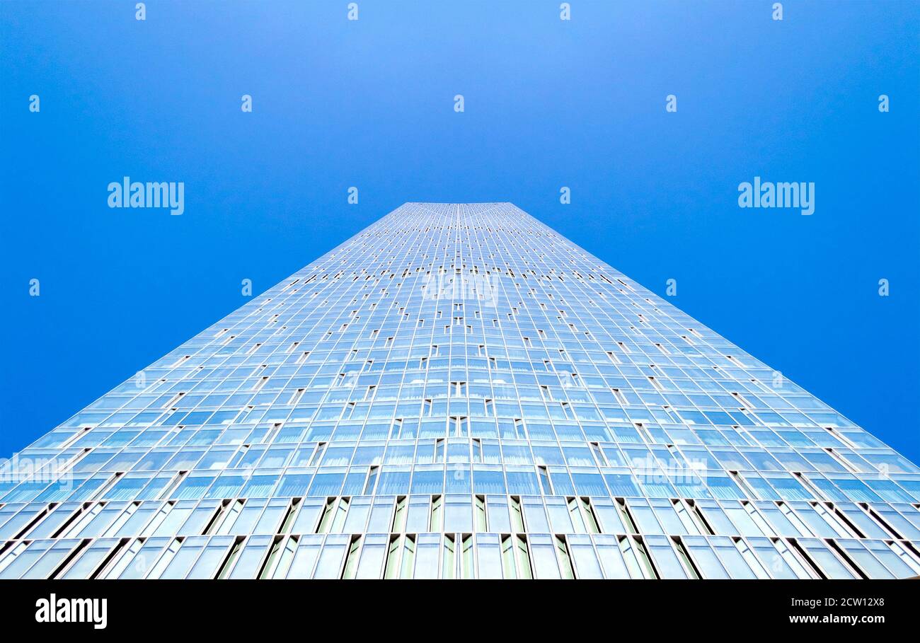 Glass modern skyscraper building opposite blue sky in perspective view ...