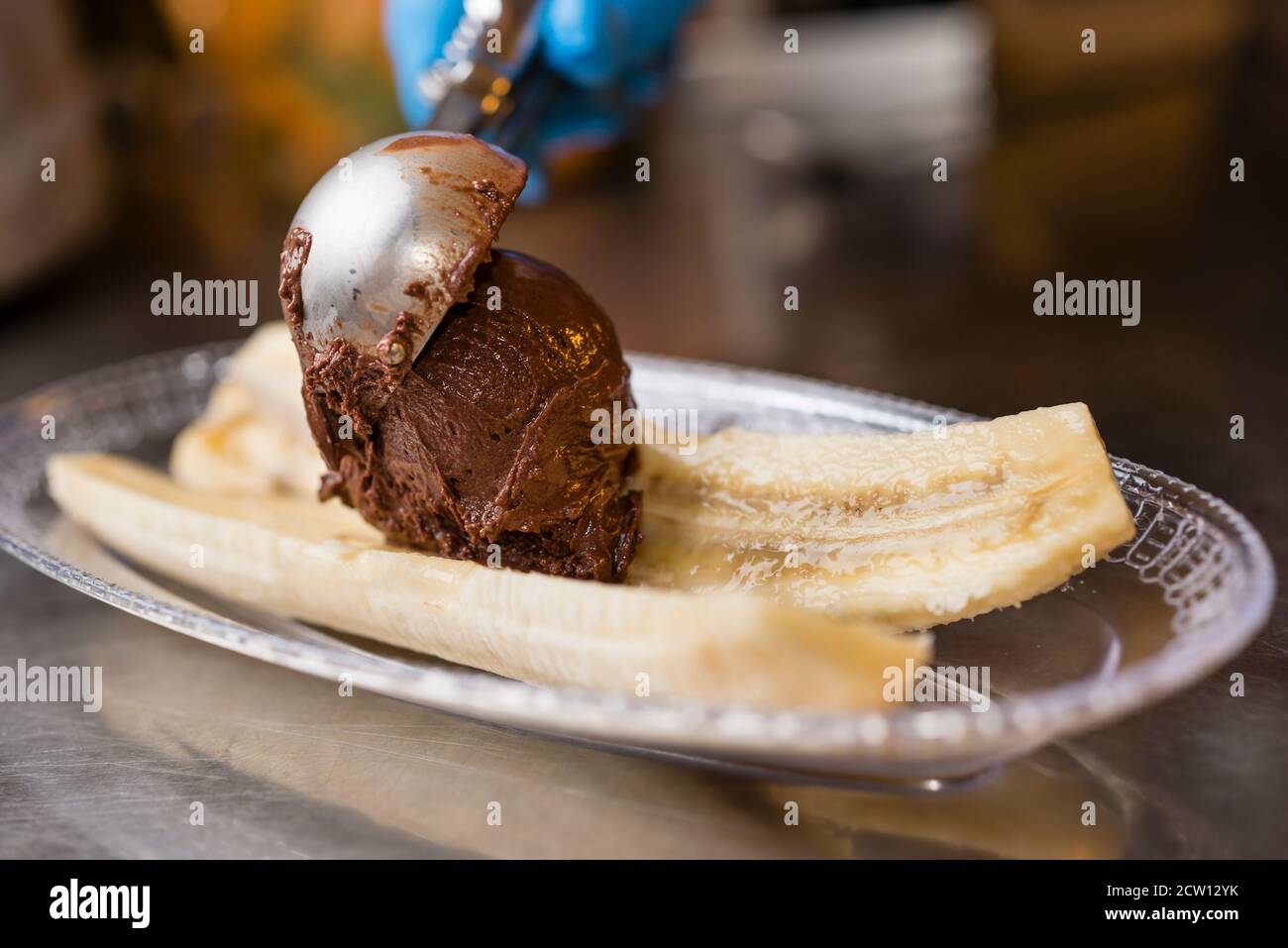 Preparation of artisanal Italian Banana split with ice cream, whipped ...