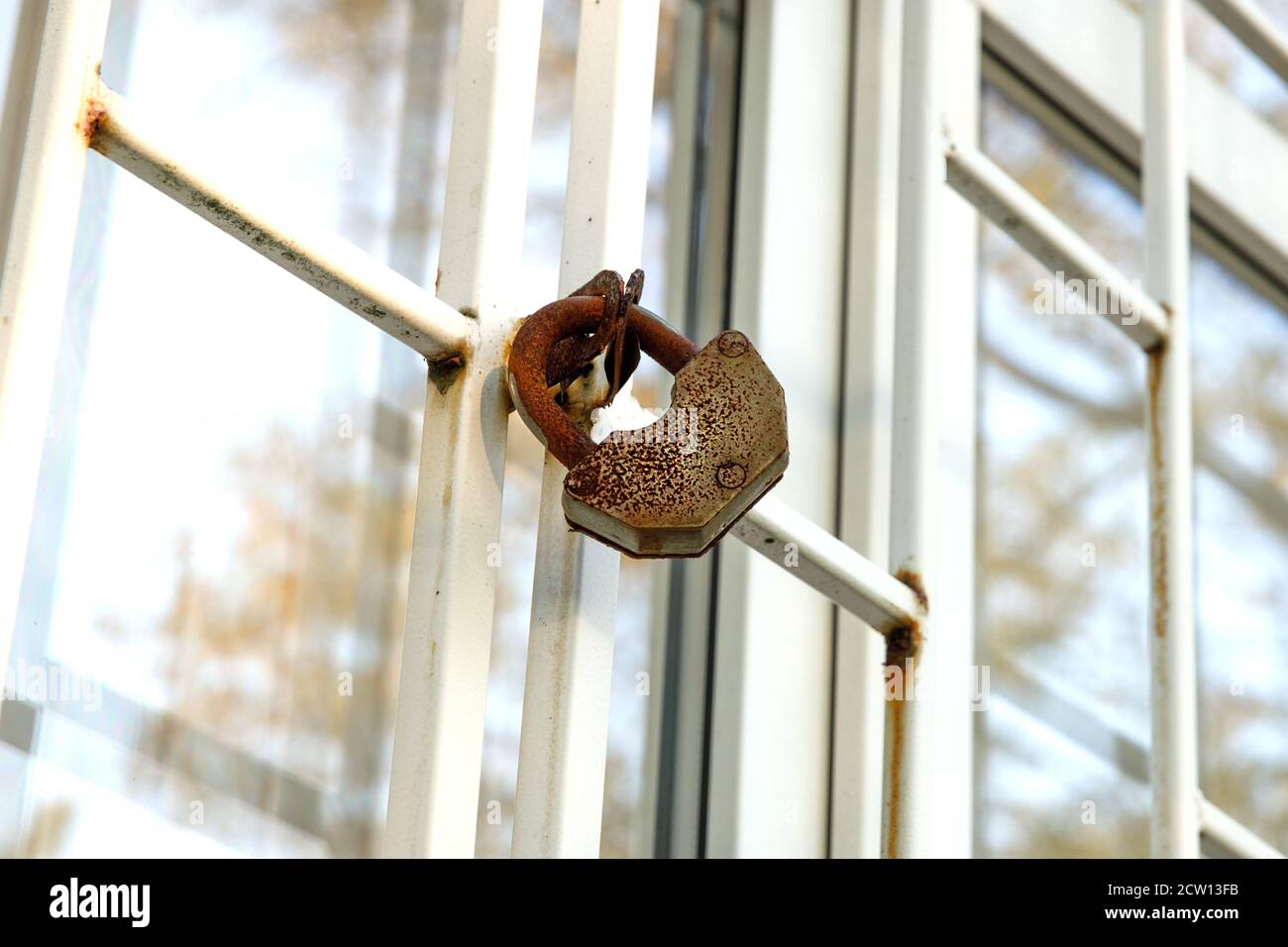 the lock hangs on a metal lattice on the window. Thief protection Stock ...