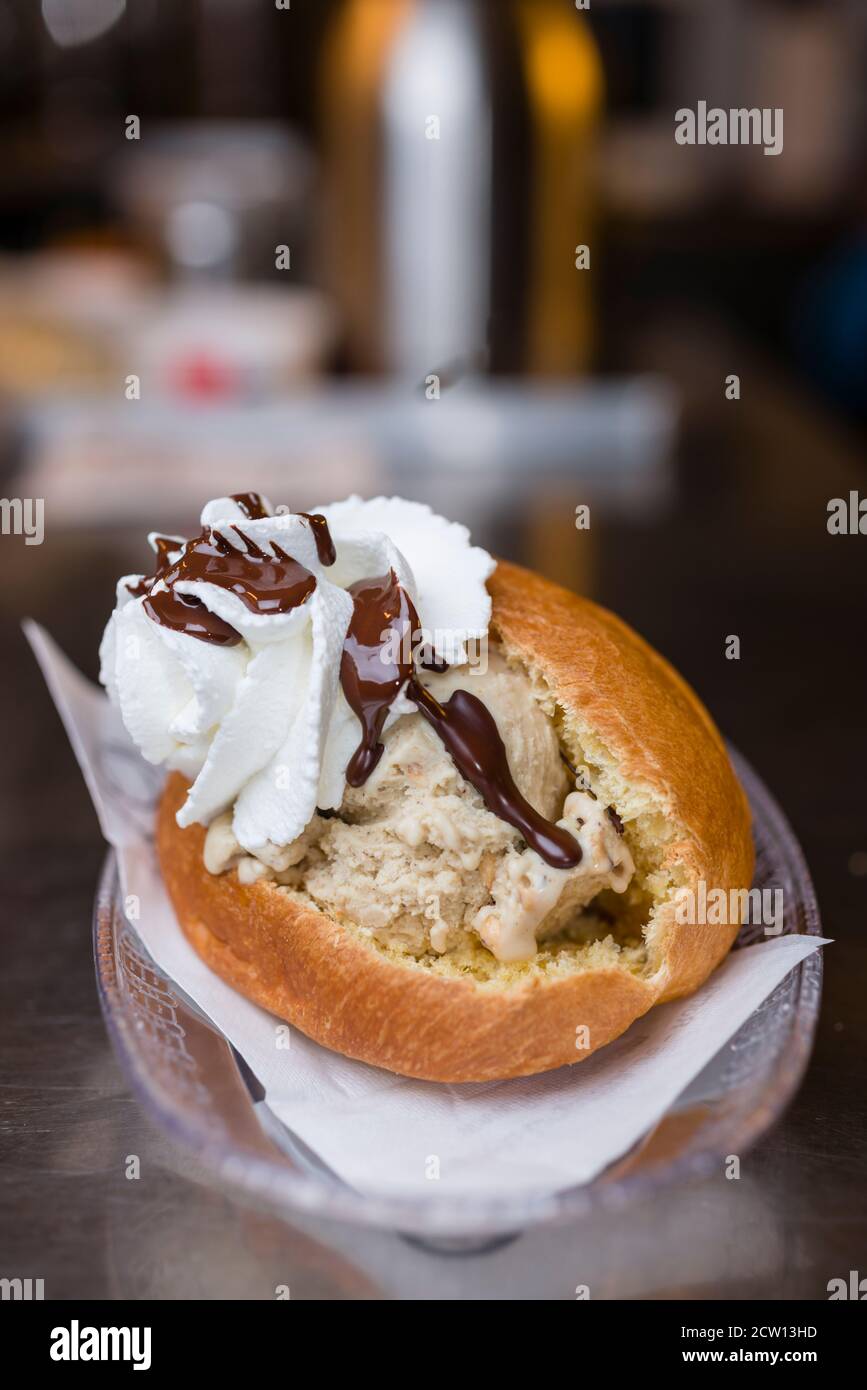 Artisan preparation of classic Italian maritozzo, sweet bun, with ice ...