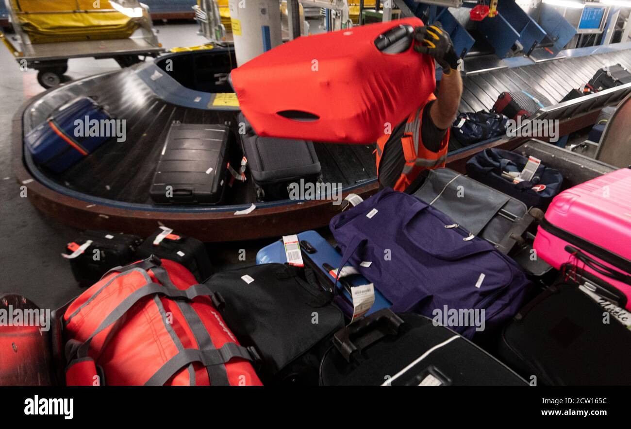 Stuttgart, Germany. 25th Sep, 2020. An airport employee lifts a ...