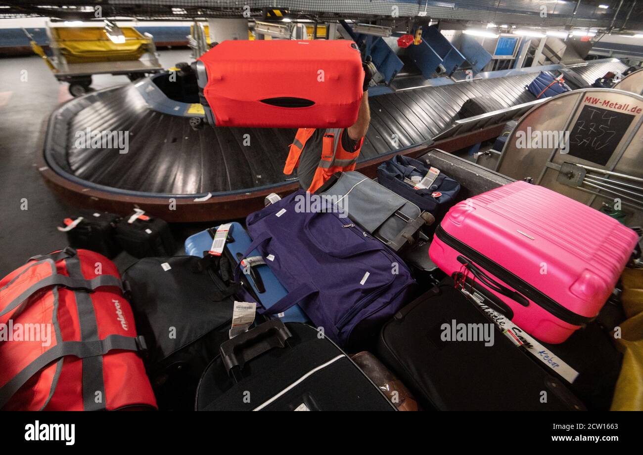Stuttgart, Germany. 25th Sep, 2020. An airport employee lifts a ...