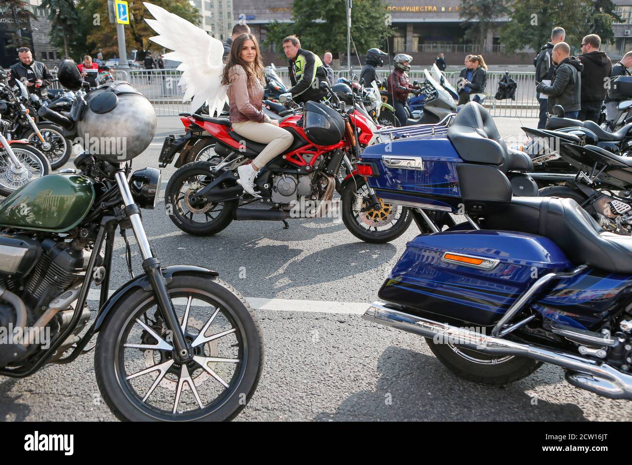 Moscow, Russia. 26th Sep, 2020. A girl wearing wings sits on a ...