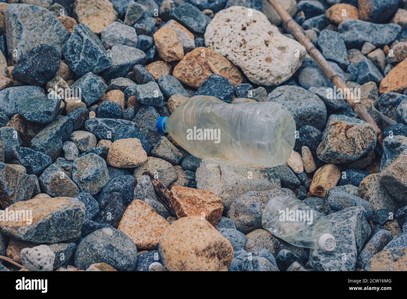 Spilled vivid multi colour garbage on stones background. Close up big ...