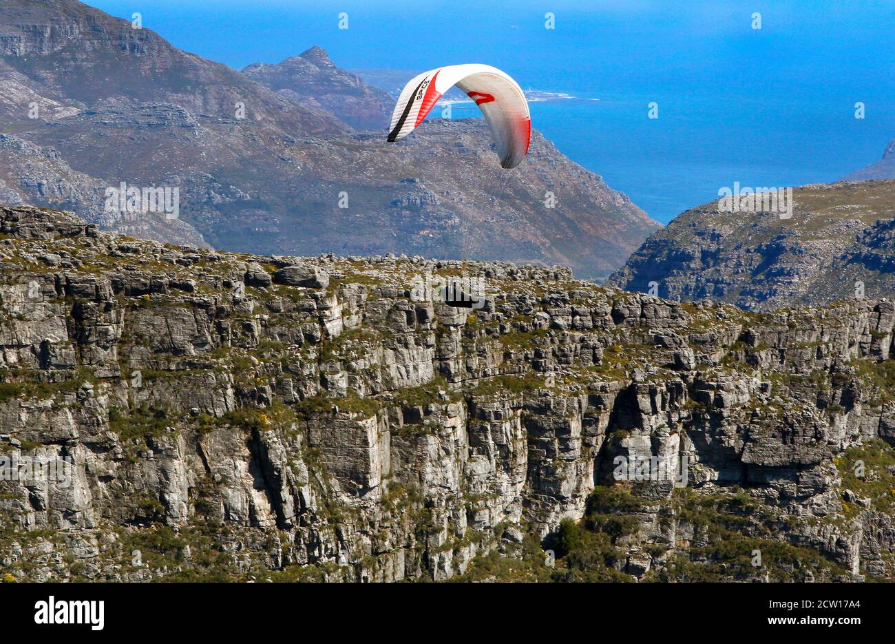 A solo paraglider flying over Table Mountain in Cape Town Stock Photo ...
