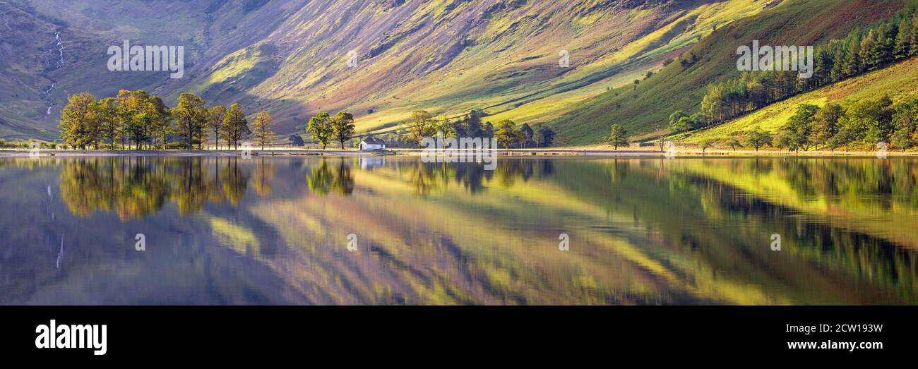 The famous Char Hut and Sentinel Trees at Buttermere are reflected in ...
