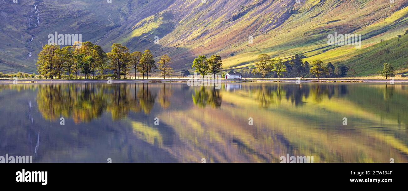 The famous Char Hut and Sentinel Trees at Buttermere are reflected in ...