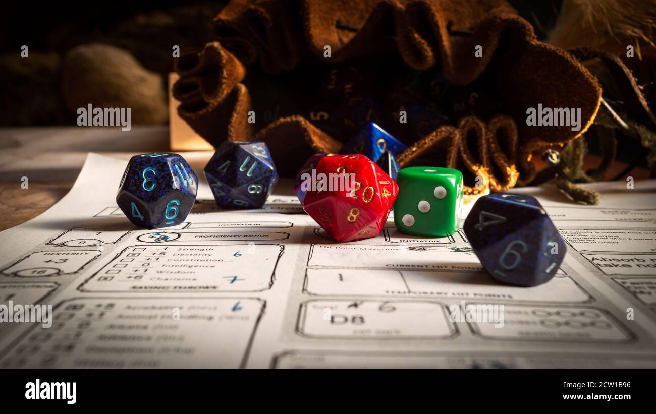 Close up of spilling out dice of different kinds from a dice bag on a ...