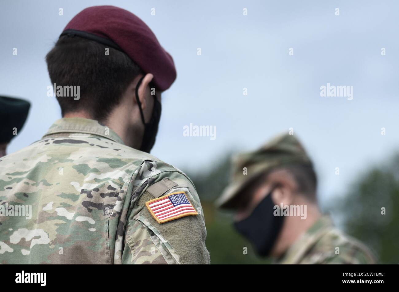 American flag on soldier arm and US soldiers wearing protective face ...