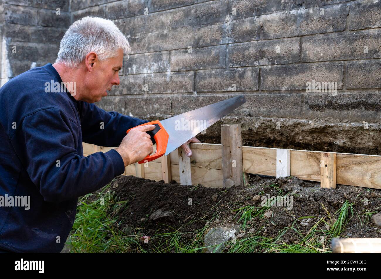 Worker sawing wood hi-res stock photography and images - Alamy