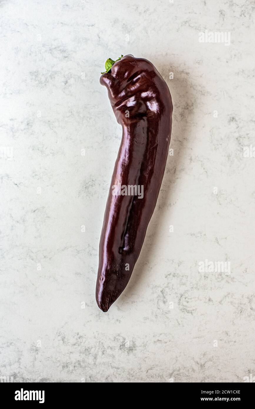 A fresh Chocolate pepper over a white marble background Stock Photo - Alamy