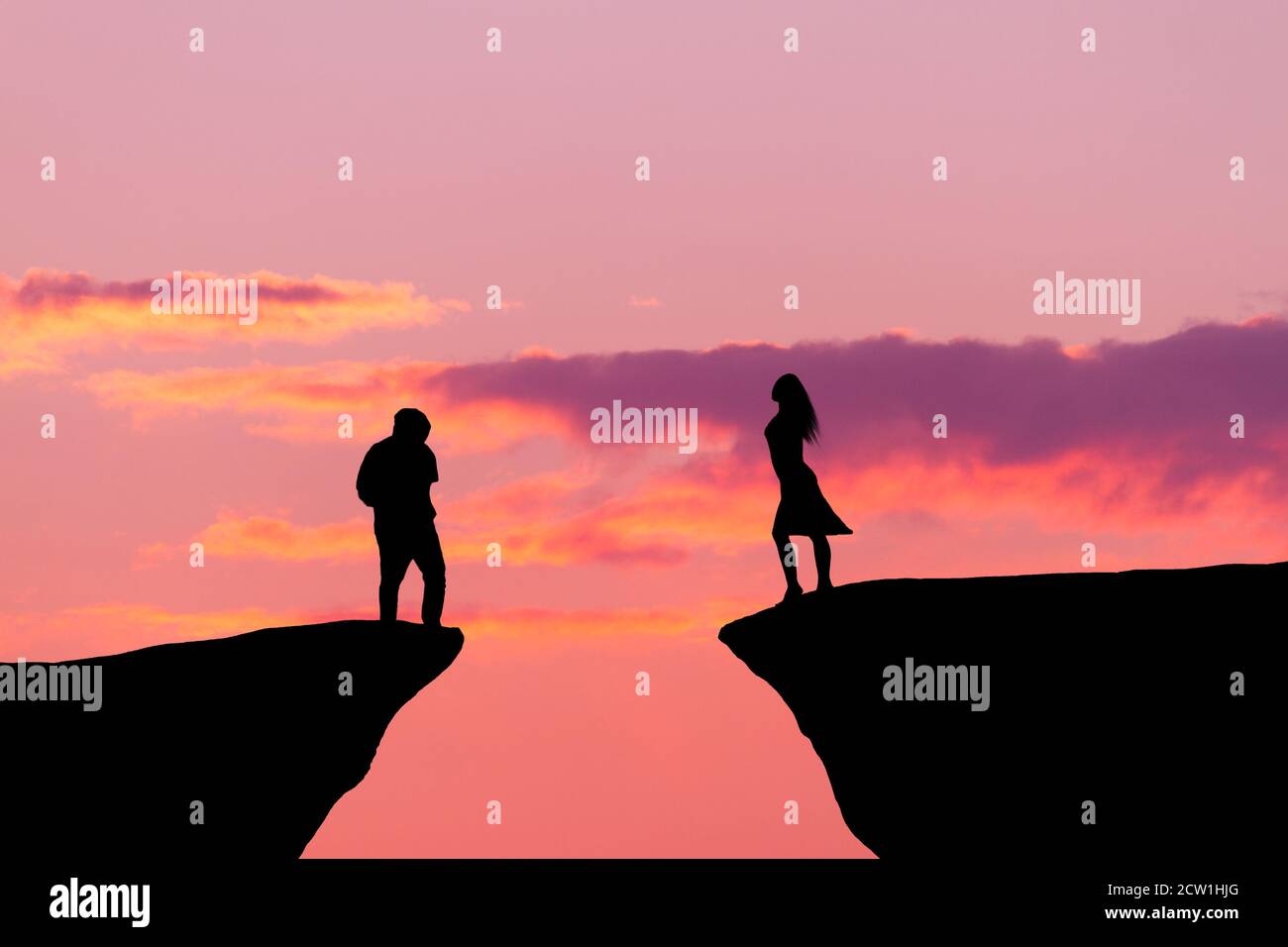 Couple on a cliff. Separated Stock Photo - Alamy