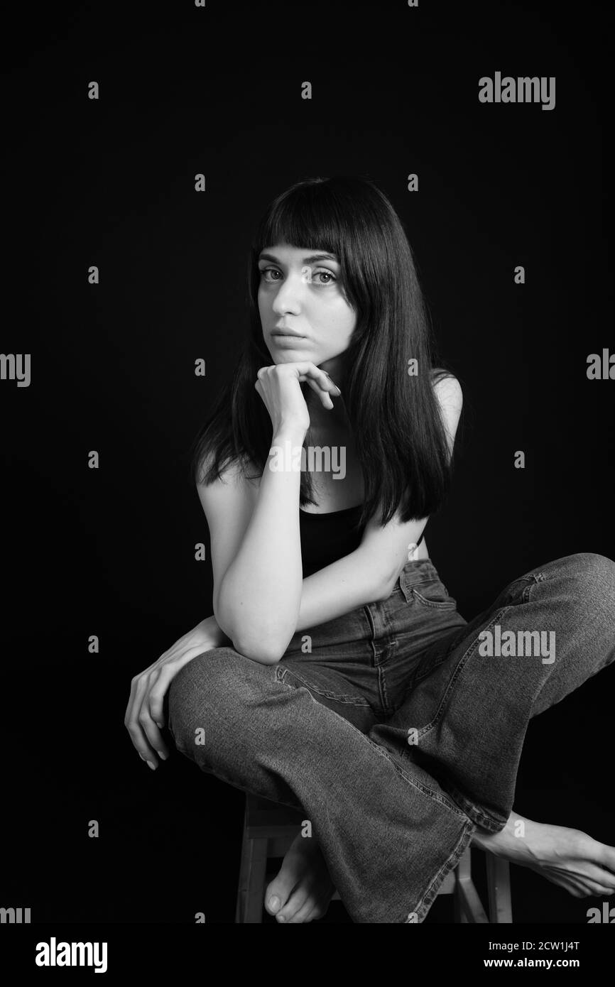 Girl crossed arms and legs Black and White Stock Photos & Images - Alamy