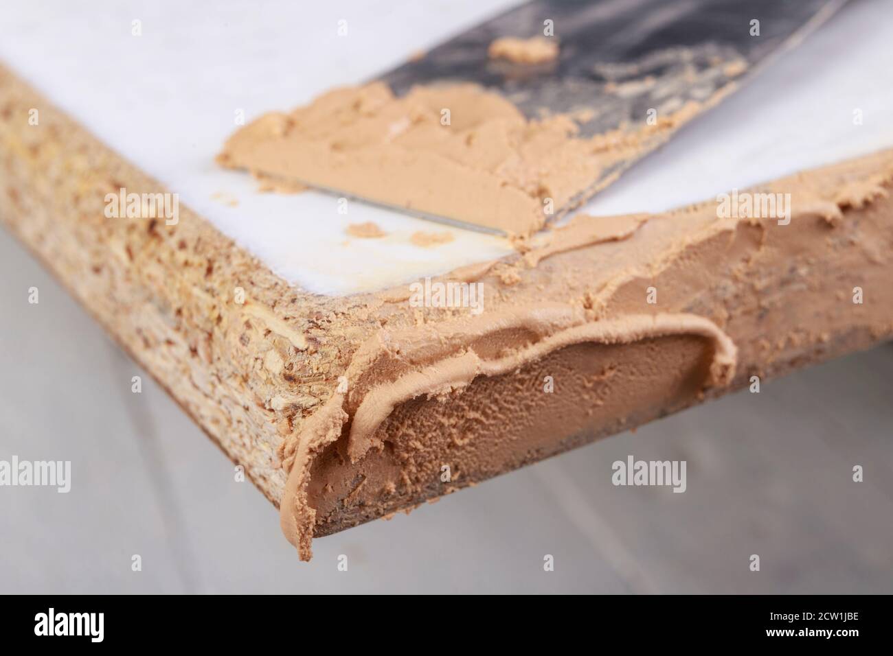 Filling chipboard with putty in a carpentry workshop. Small carpentry ...