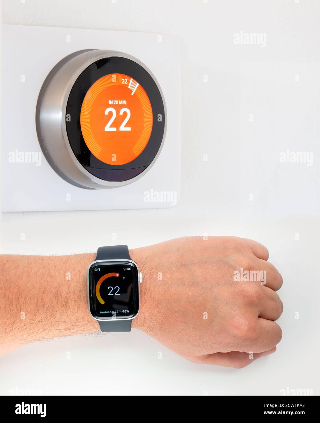 A person checking the room temperature with a smart watch connected to ...