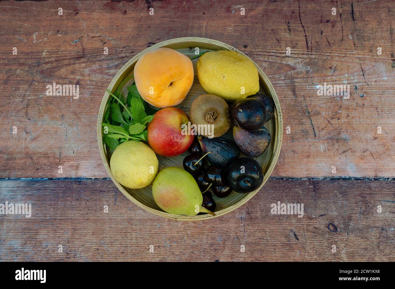 organic wet fruit tray on wooden table Stock Photo - Alamy