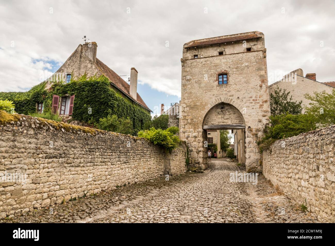 Charroux, France. Half-timbered house and church tower in one of the ...