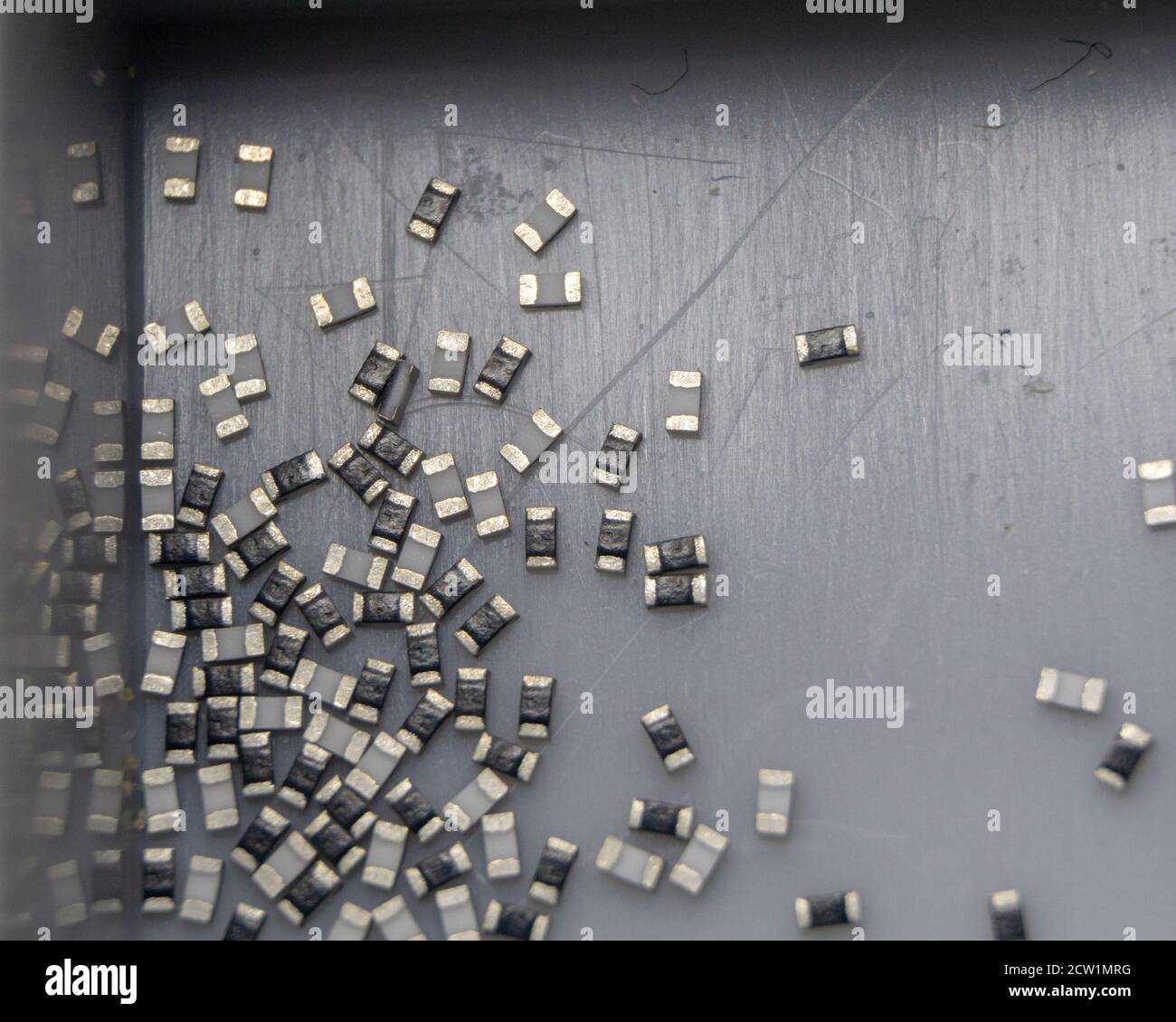 Grey scattered microscopic SMT surface mount chip resistors sorted in ...