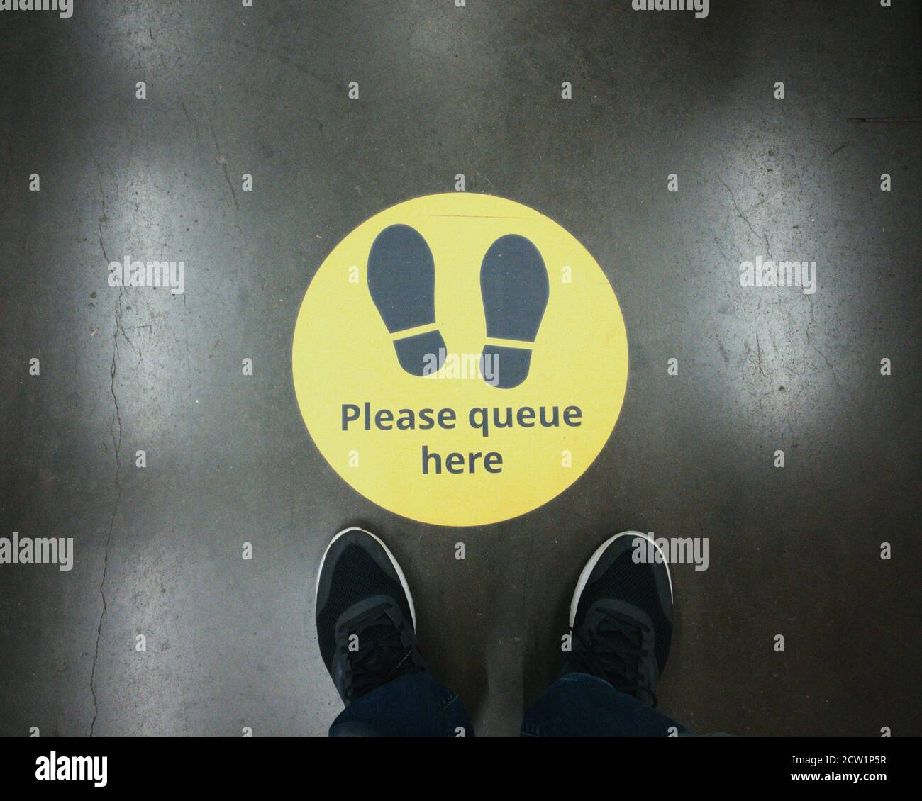 Yellow warning sign to maintain queue during covid-19 coronavirus ...