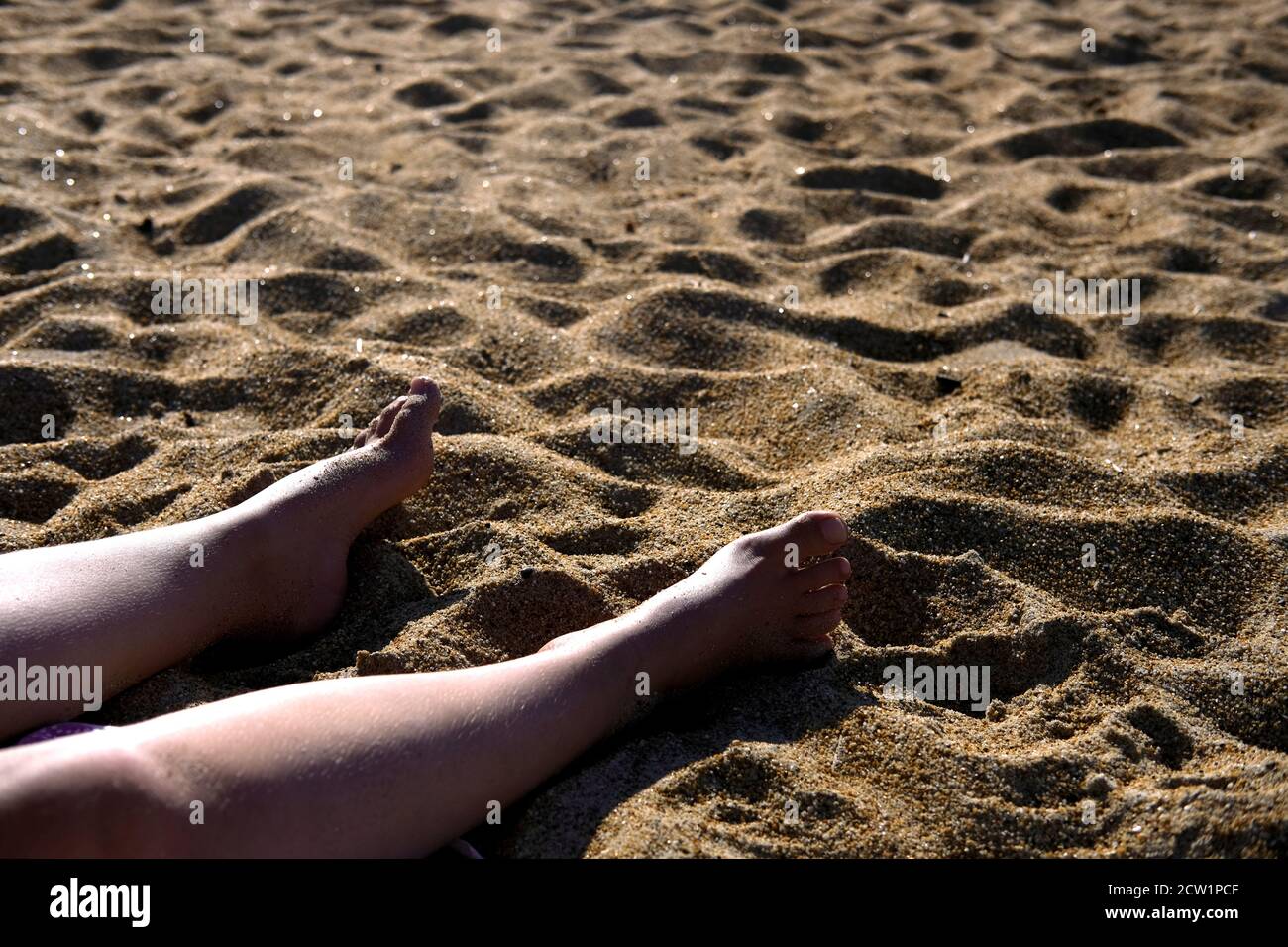 Person laying on the sand and sunbathing in the beach Stock Photo - Alamy