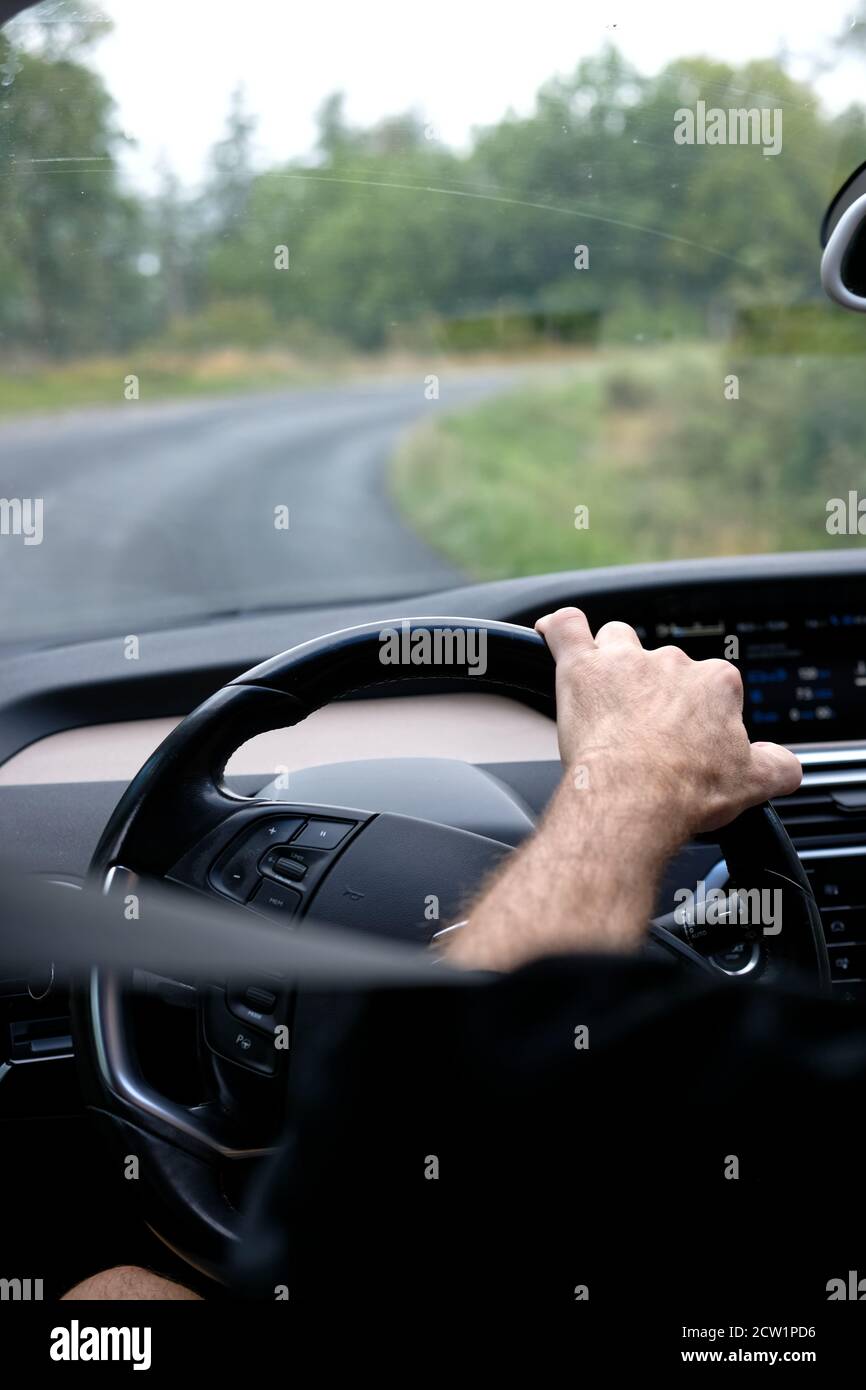 Vertical shot of a man driving a car Stock Photo - Alamy