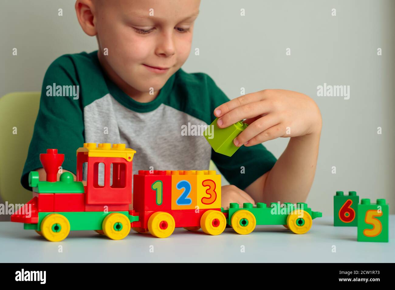 Child playing with a train, blocks of numbers. Educational toys for ...
