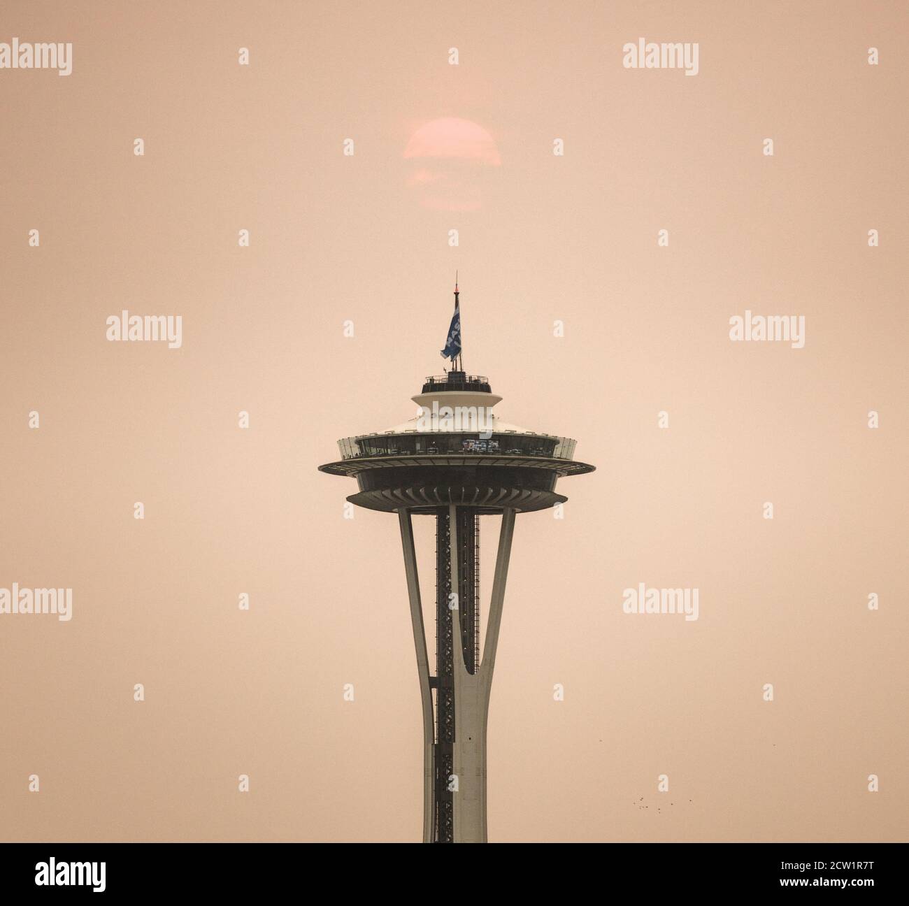 The iconic Seattle Space Needle and setting sun enshrouded in smoke ...