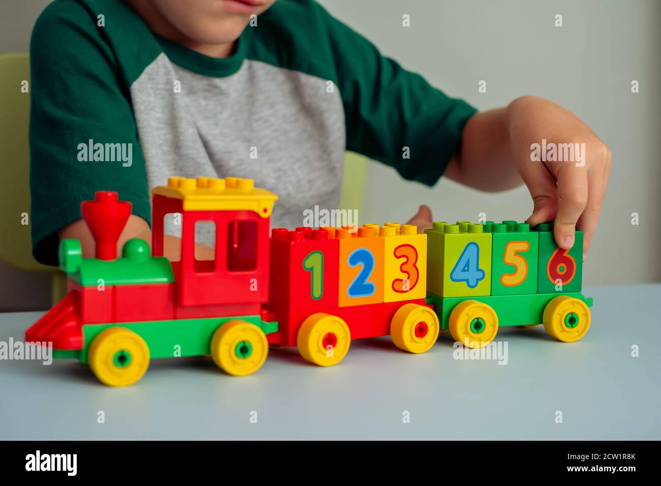 Child playing with a train, blocks of numbers. Educational toys for ...