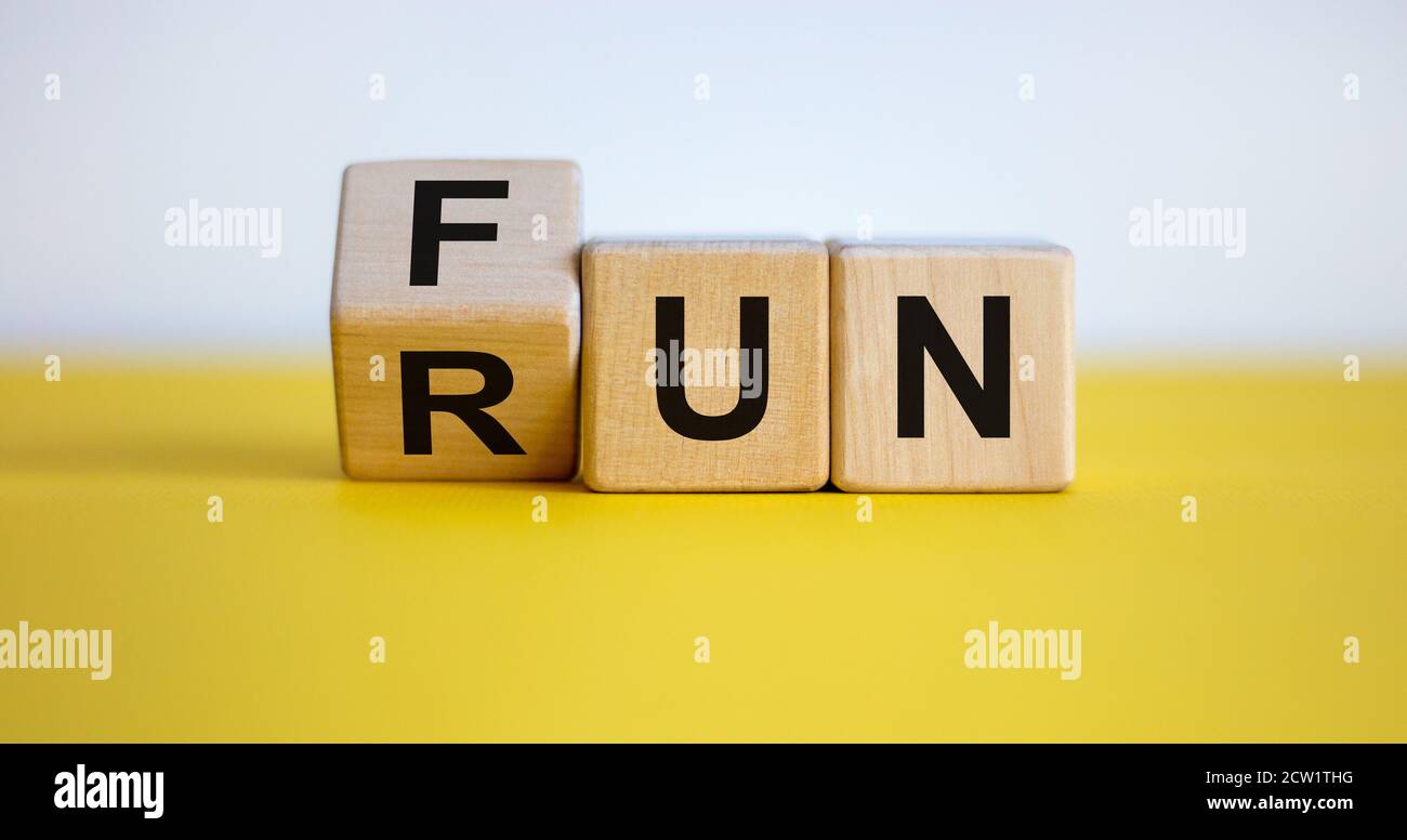 Hand is turning a cube and changes the word Fun to Run. Beautiful ...