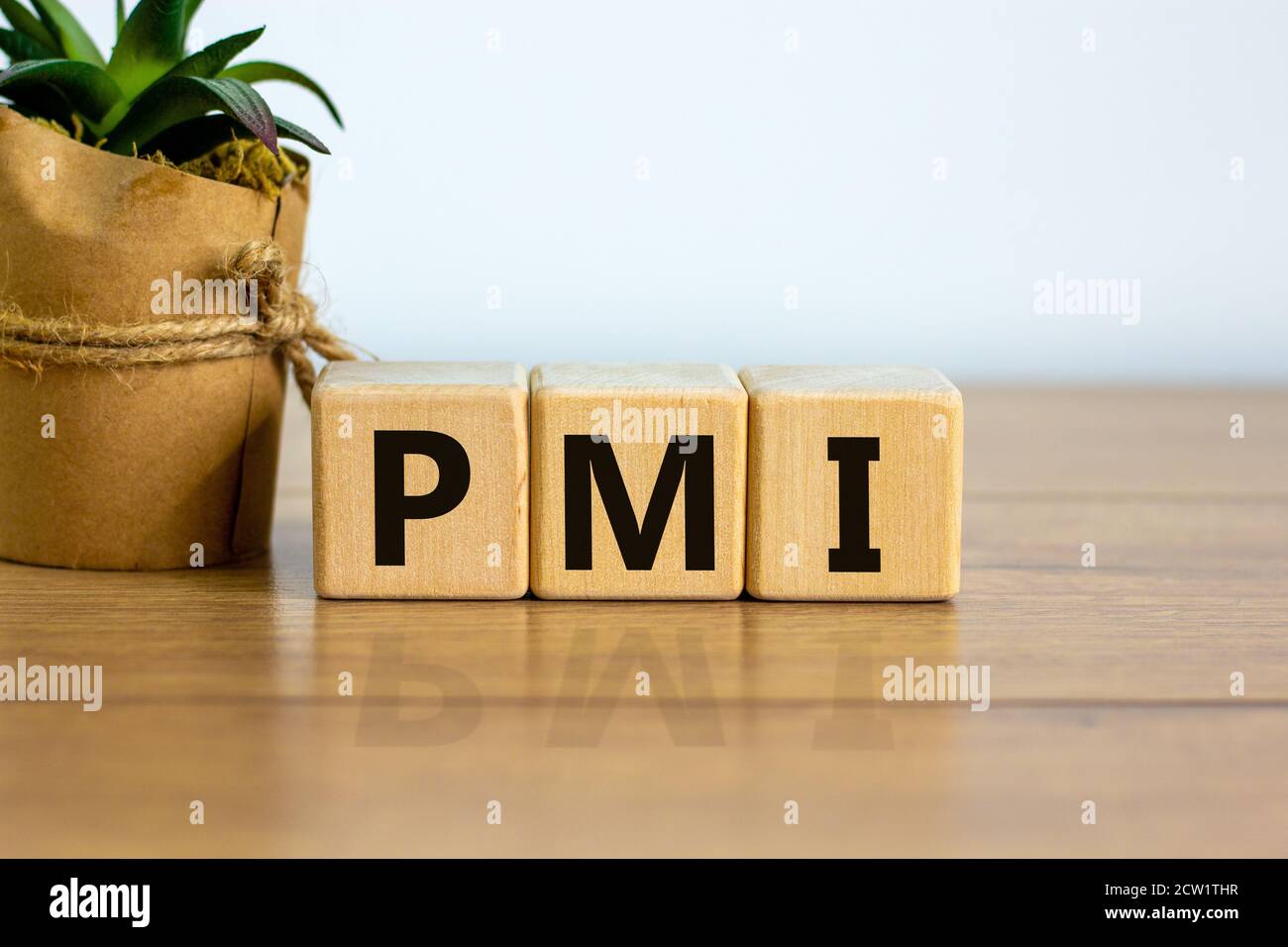 Concept word 'PMI' on cubes on a beautiful wooden table. White ...