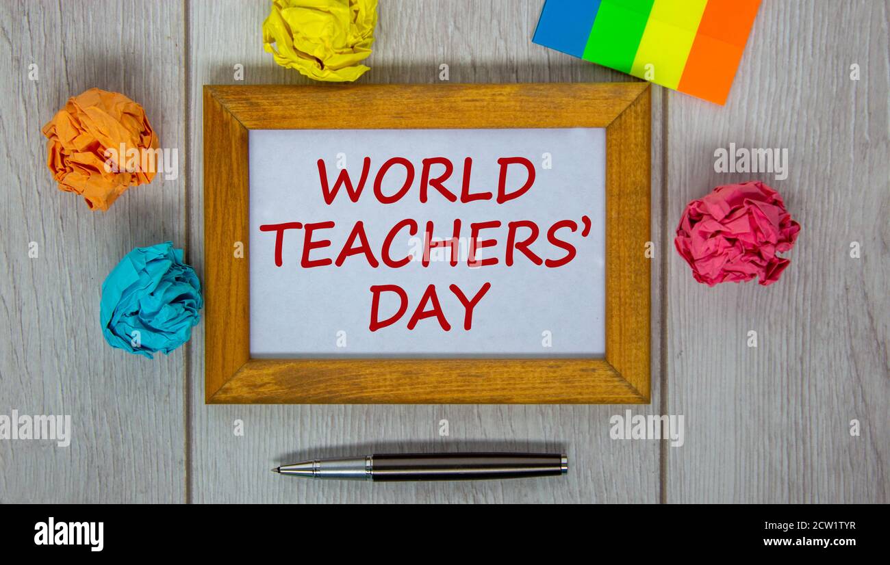 Wooden frame with inscription 'World Teachers' Day' on beautiful wooden ...