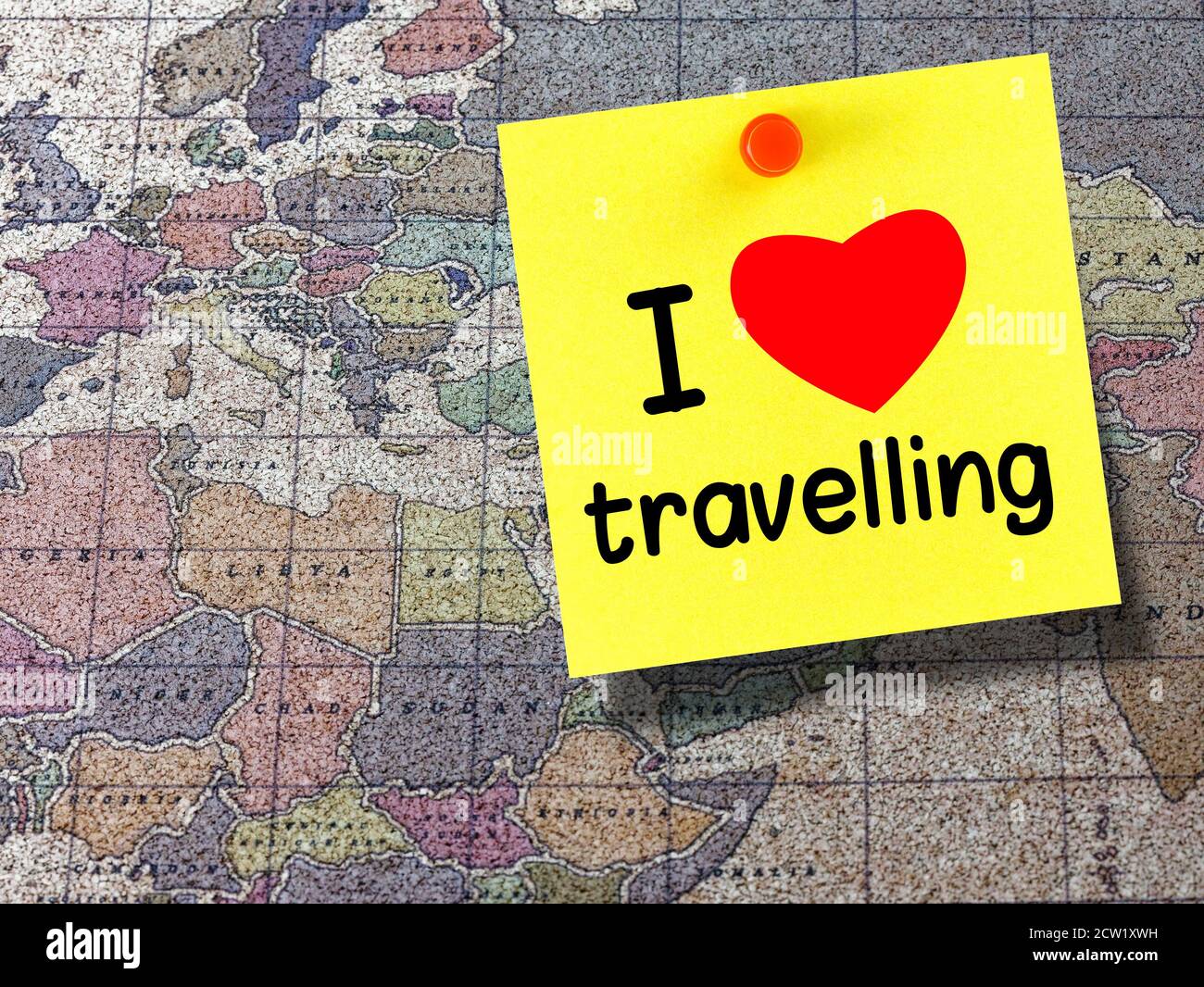 I love travelling sticky note on cork map world Stock Photo - Alamy