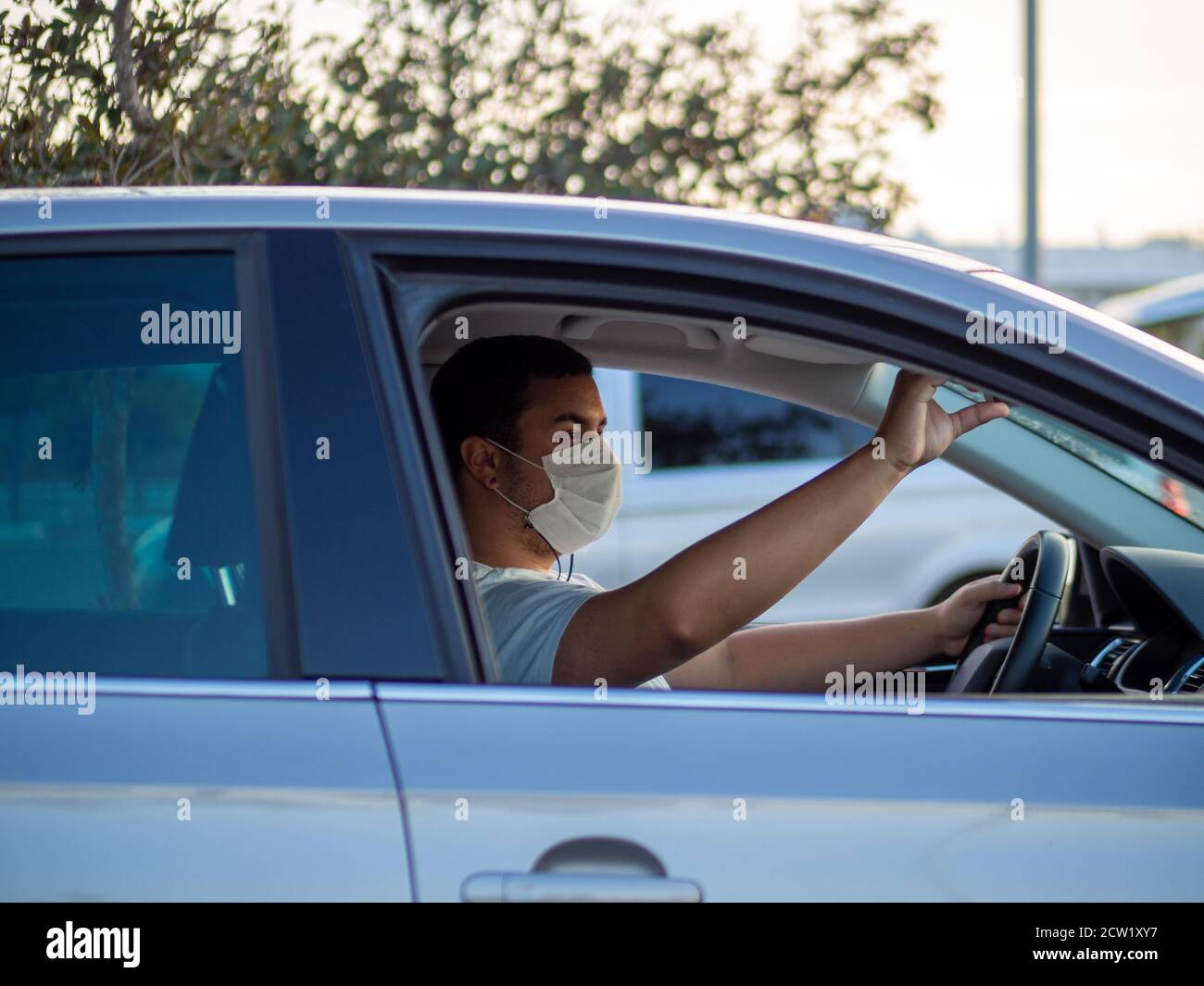 Male fixing the mirror while driving a car Stock Photo - Alamy