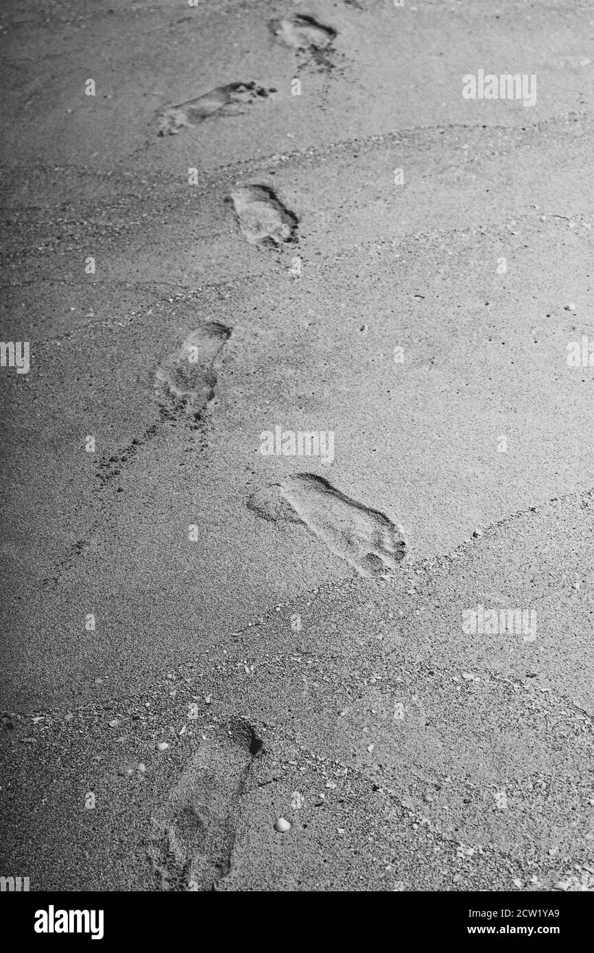 Vertical shot of footsteps on grey sand texture Stock Photo - Alamy