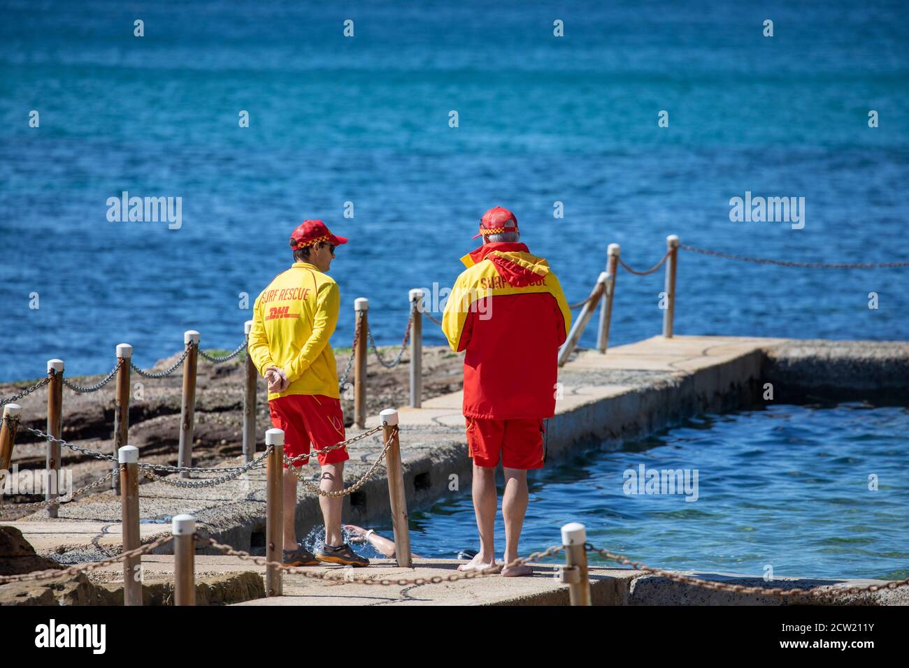 Australian volunteer lifeguards surf rescue personnel beside a beach ...