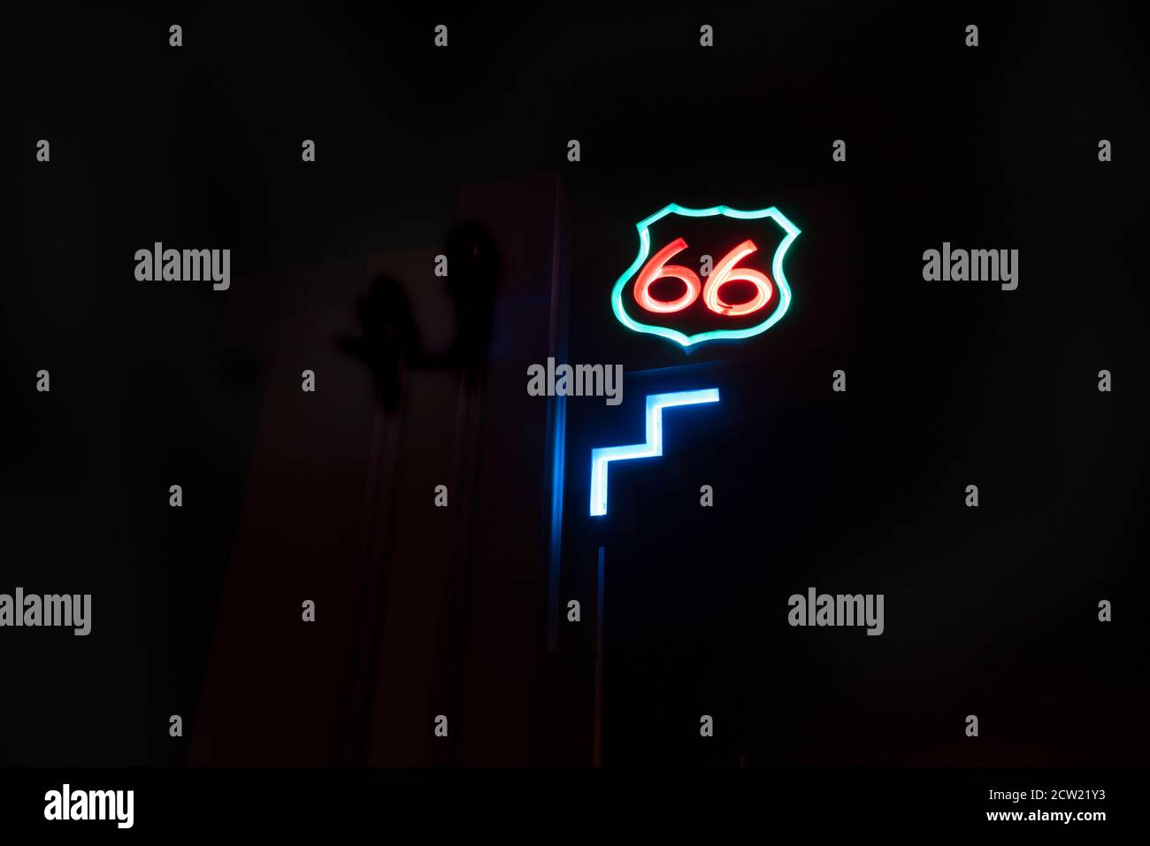 Route 66 bright simple neon sign illuminated against dark night sky ...
