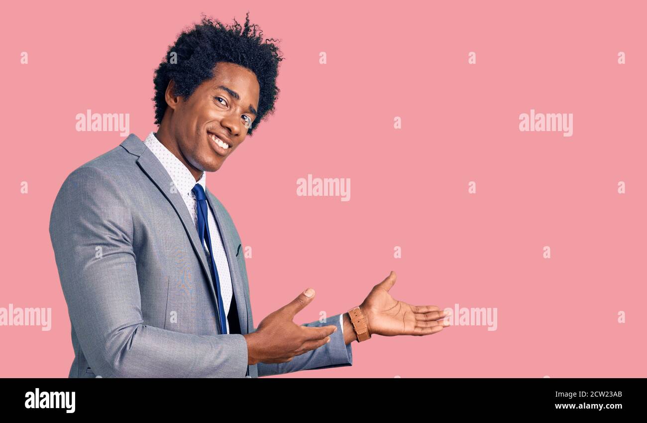 Handsome african american man with afro hair wearing business jacket ...