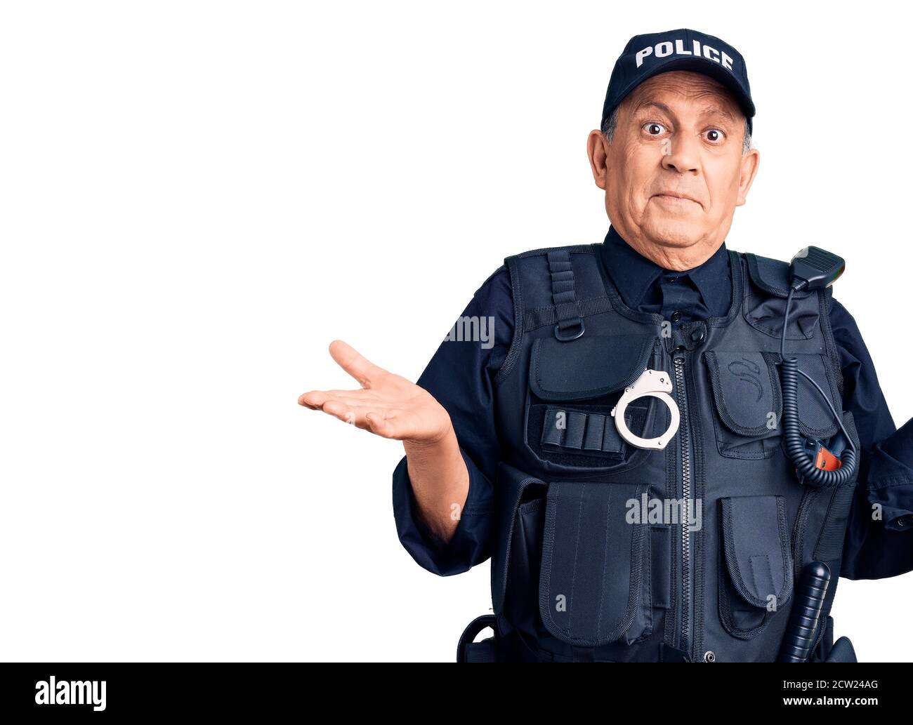 Senior handsome man wearing police uniform clueless and confused ...