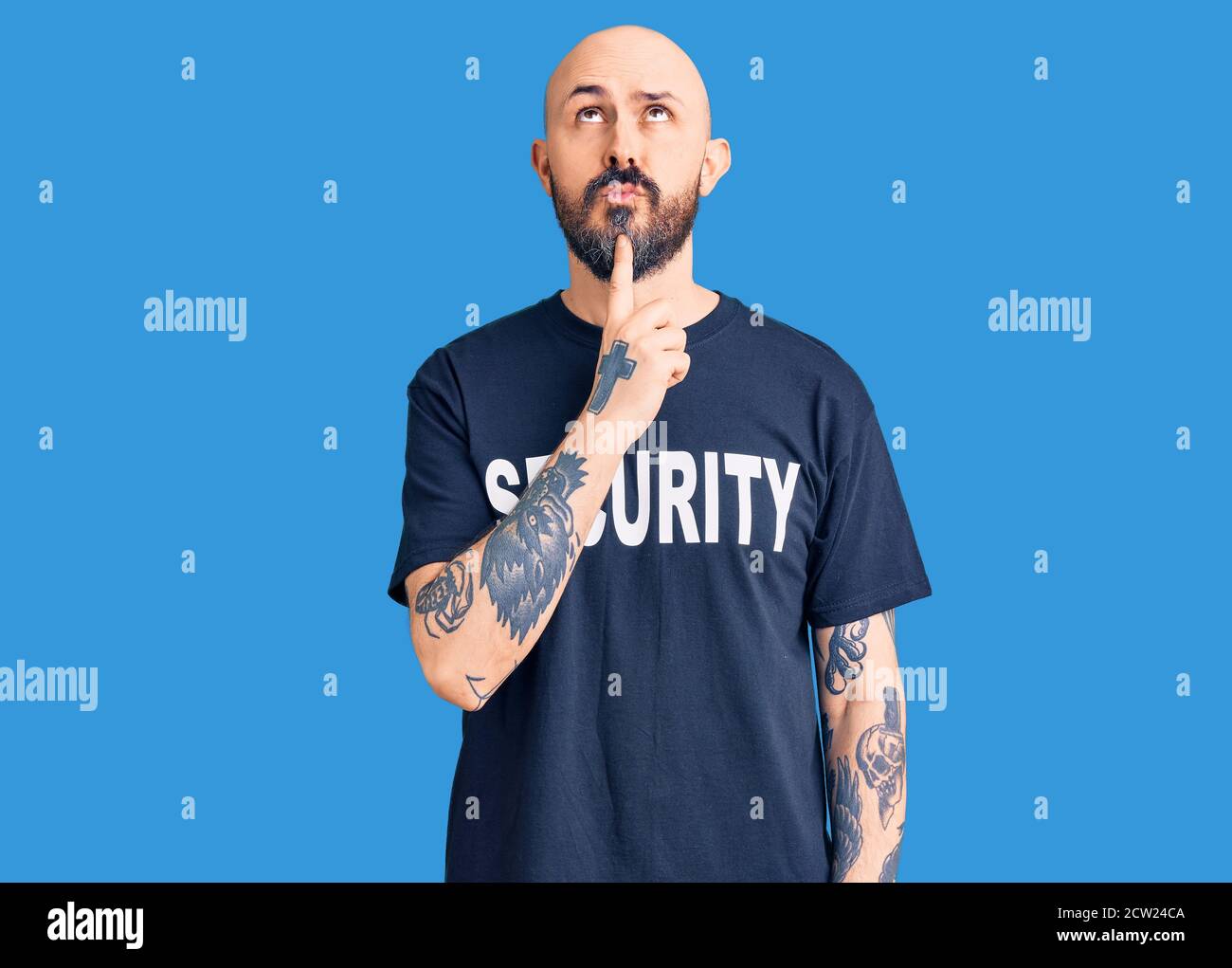 Young handsome man wearing security t shirt thinking concentrated about ...