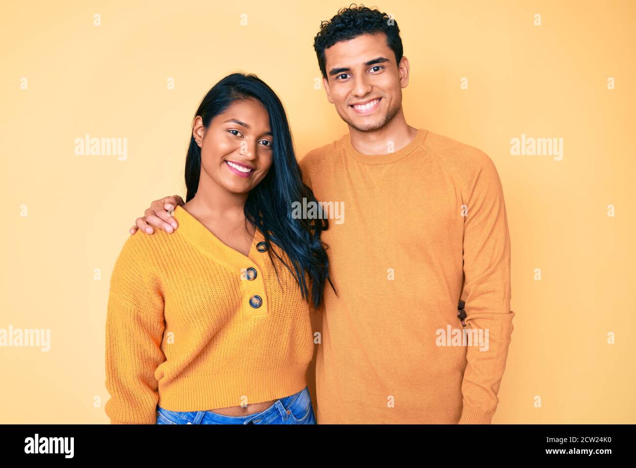 Beautiful latin young couple wearing casual clothes together with a ...