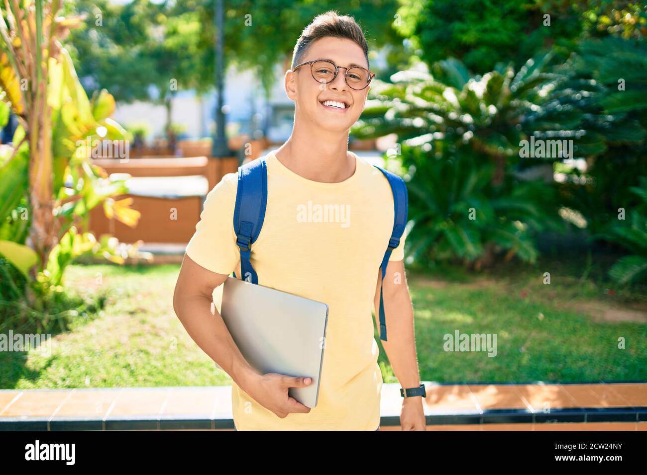 Young hispanic student smiling happy walking the university campus ...