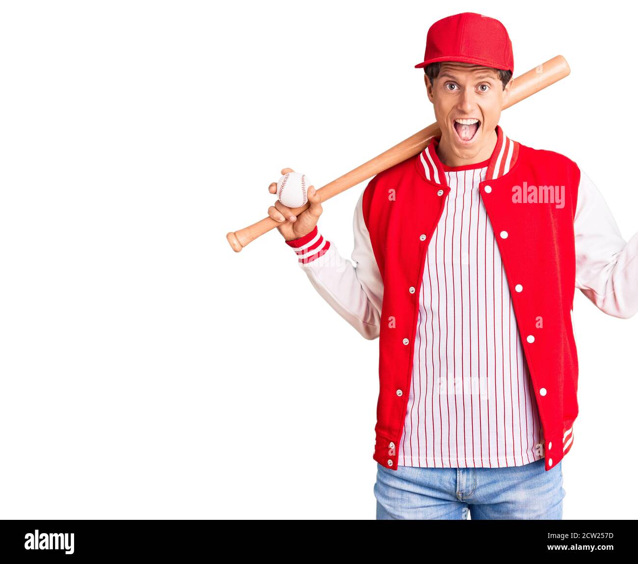 Young handsome man playing baseball holding bat and ball celebrating ...