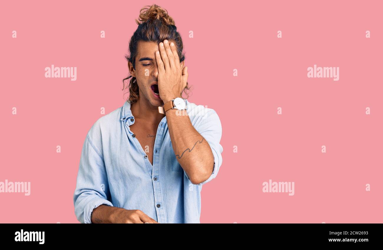Young hispanic man wearing summer style yawning tired covering half ...