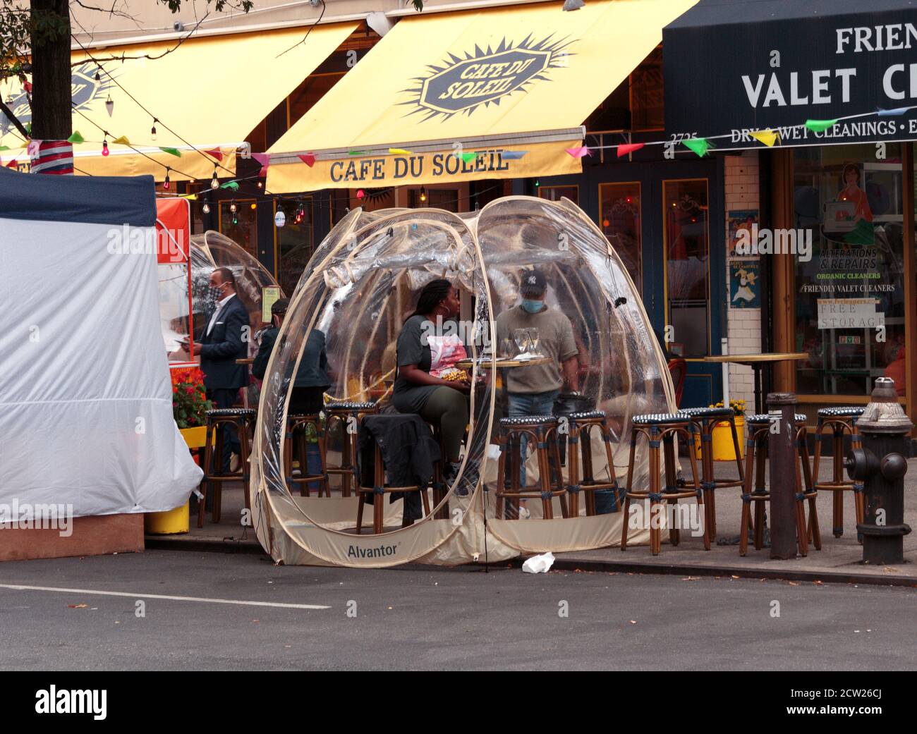 diners inside an outdoor dining pod in front of Cafe Du Soleil ...