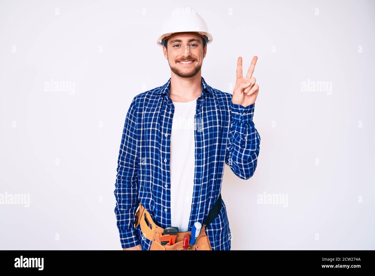 Young handsome man weaing handyman uniform smiling with happy face ...